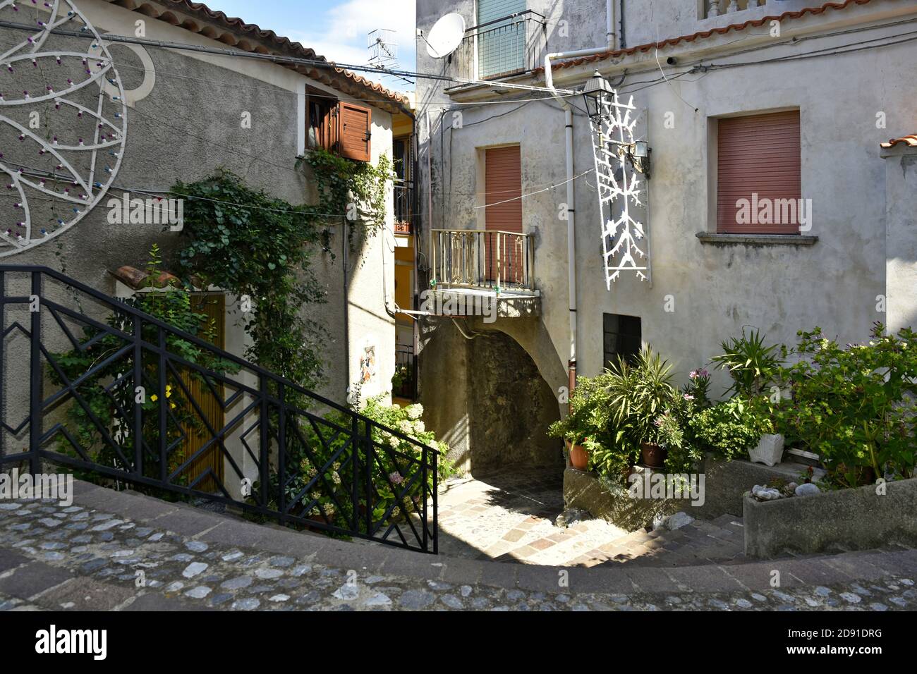 A narrow street among the old houses of Grisolia, a rural village in ...