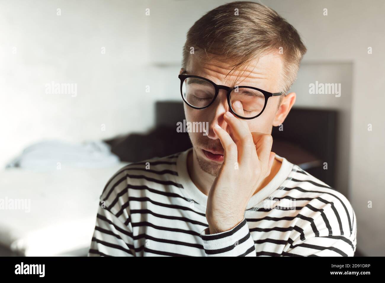 Tired man taking off glasses rubbing dry irritated eyes to relieve pain ...