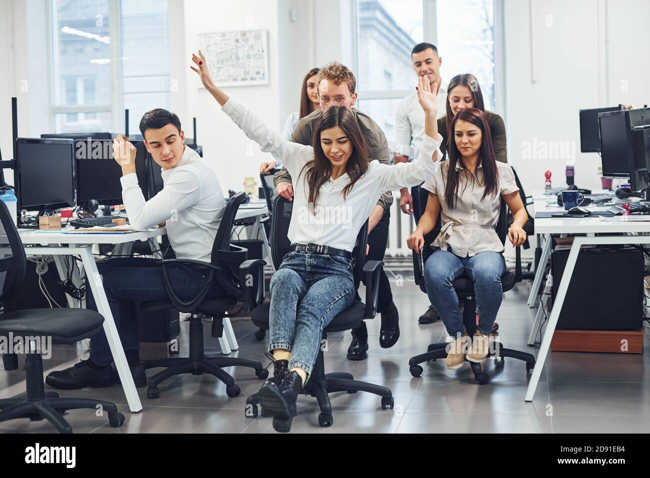 Positive young people have fun at break time in the office Stock Photo ...