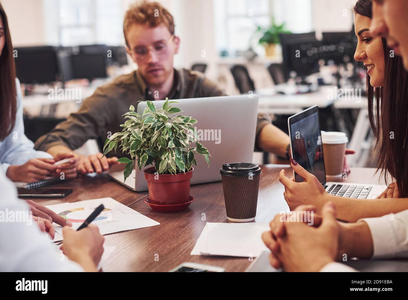 Sitting by the table. Young business people working together in the ...