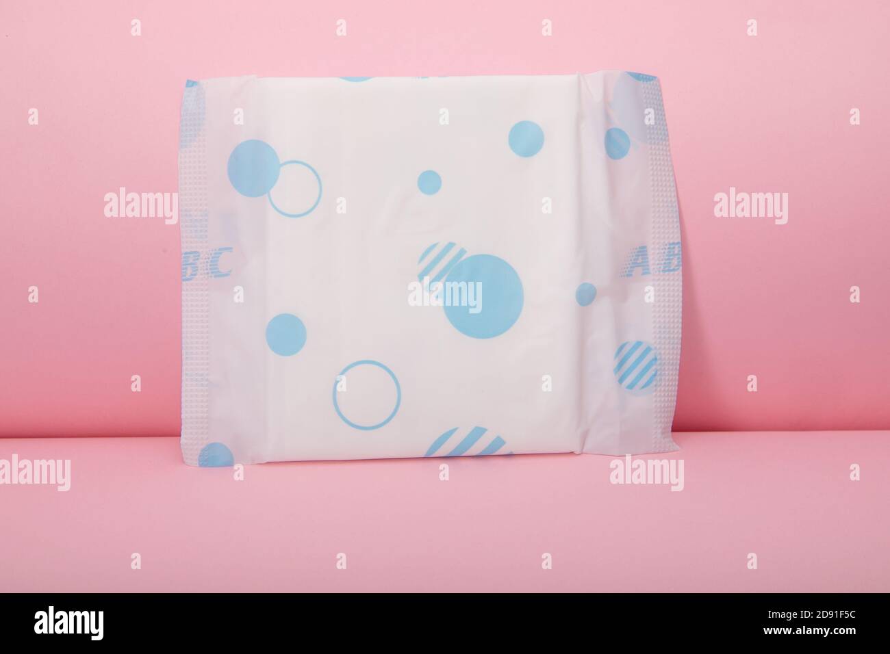 Closed sanitary pad on a pink background Stock Photo - Alamy
