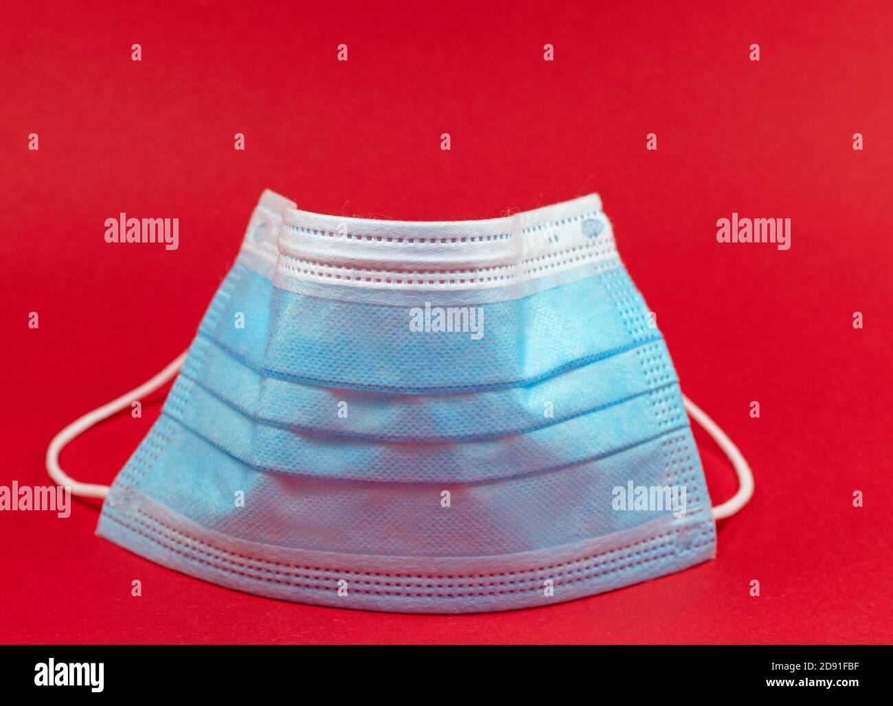 Disposable breathing mask isolated against a red background Stock Photo ...