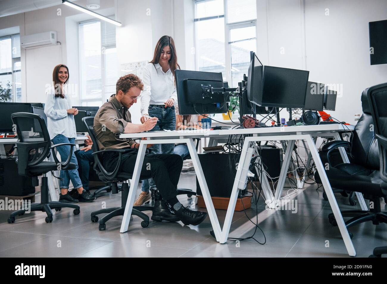 Group of young business people that working by computers in the modern ...