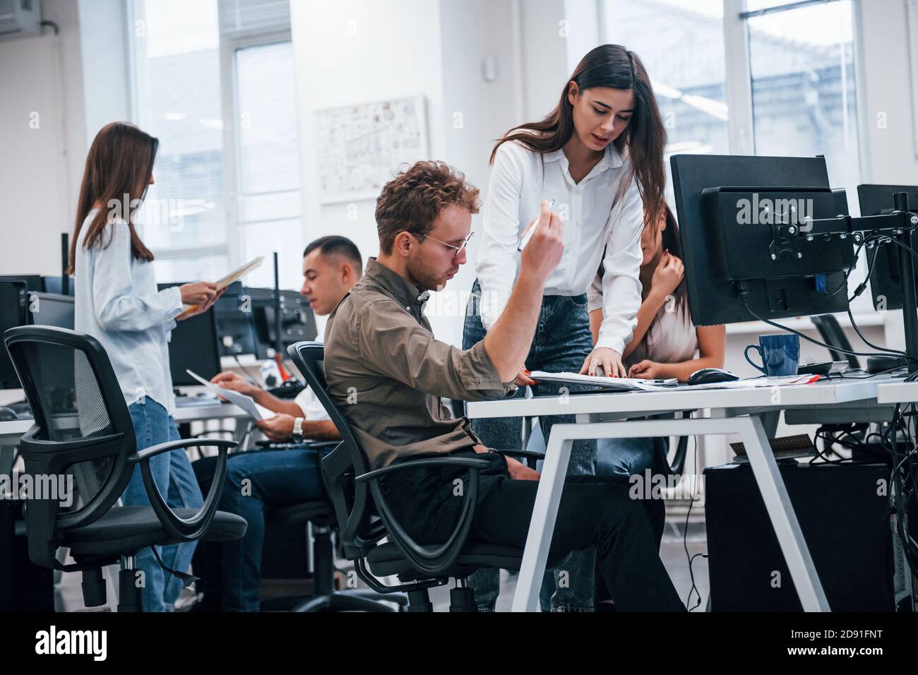 Group of young business people that working by computers in the modern ...