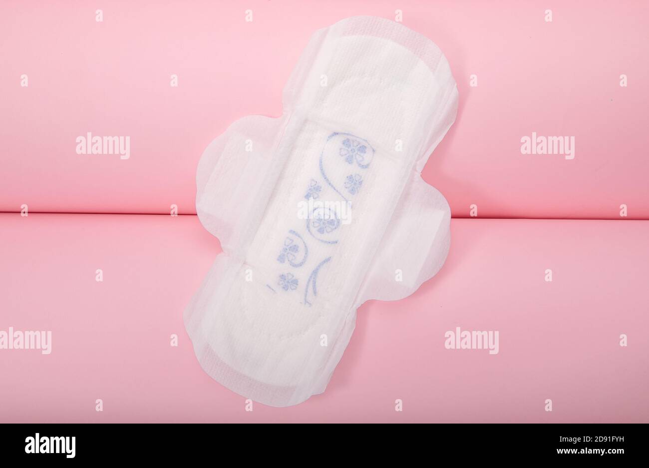 Sanitary pad on a pink background Stock Photo - Alamy