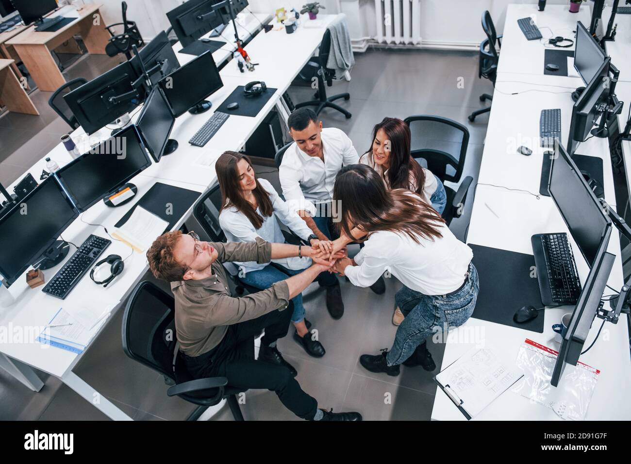 People talking and working together in the modern office near computers ...