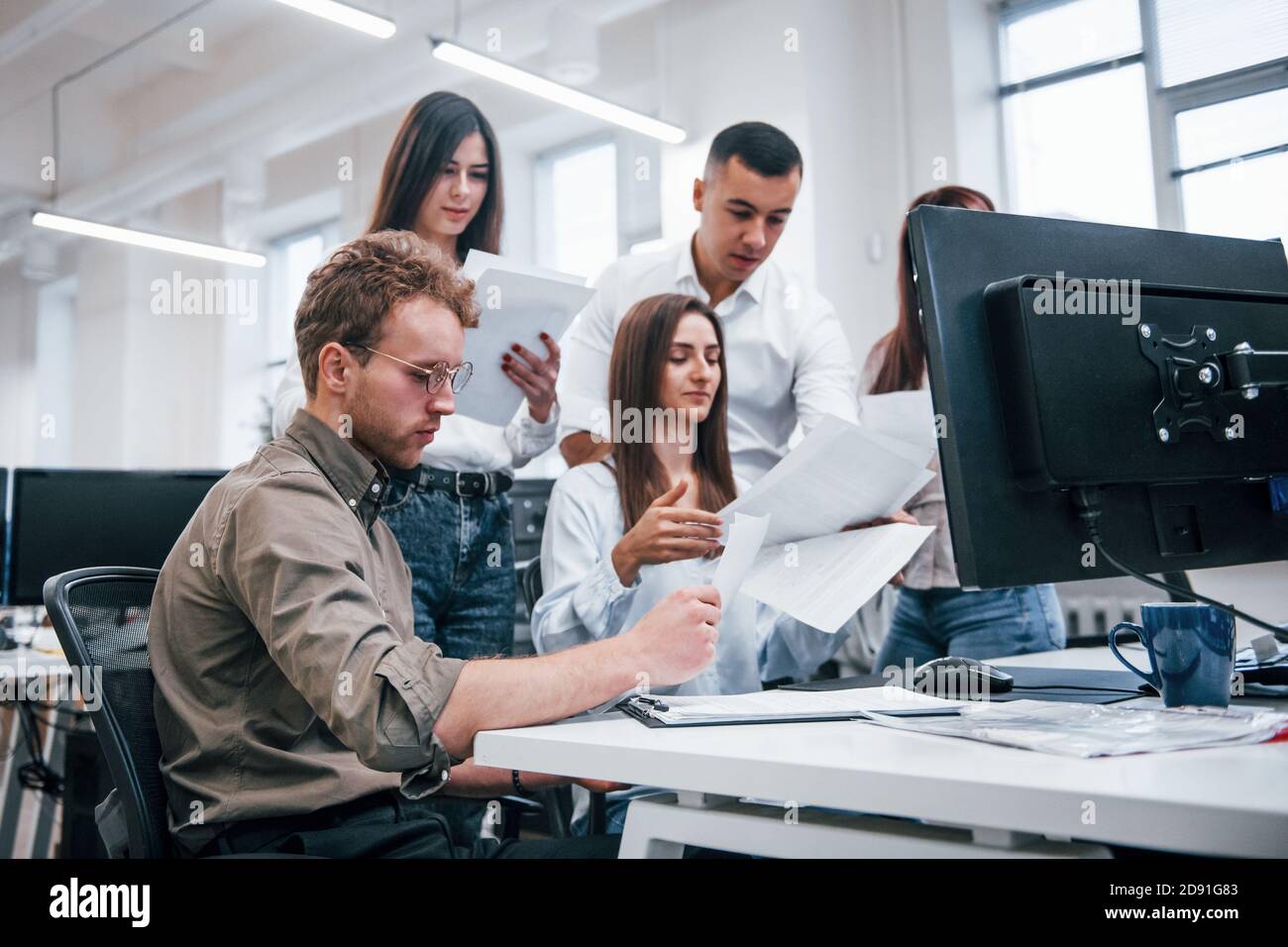 Group of young business people that working by computers in the modern ...