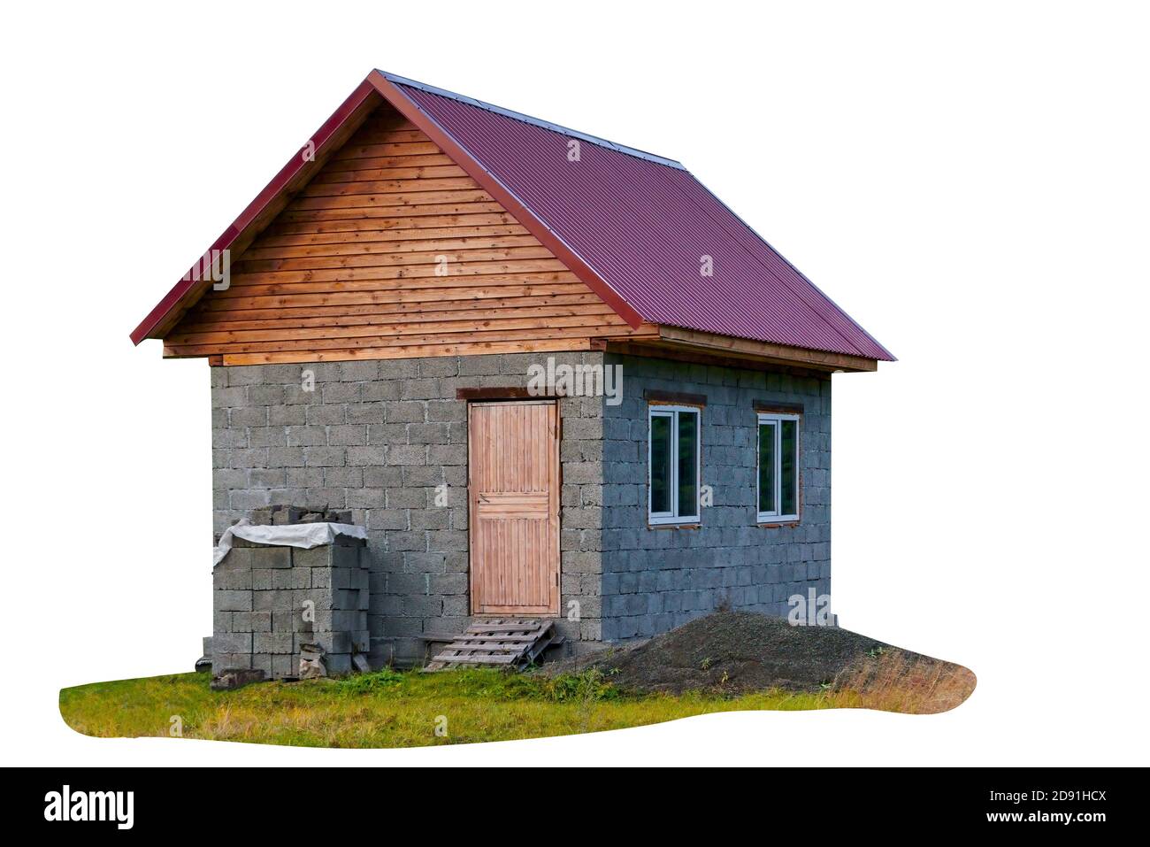 A small one-story house under construction from cinder blocks with a ...