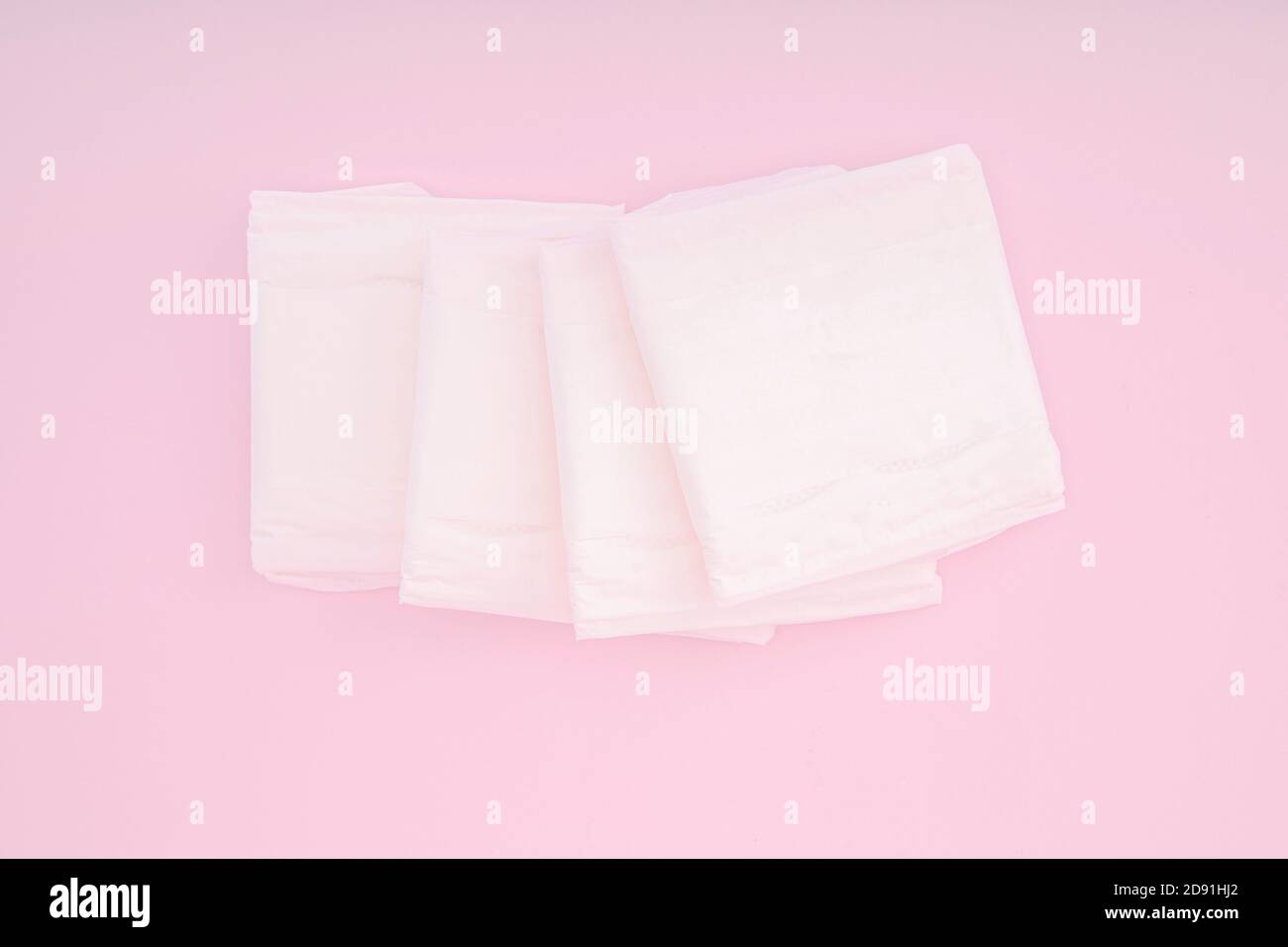 Sanitary pads on a pink background Stock Photo - Alamy