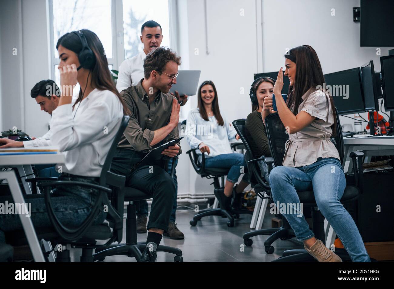 Inside of call center. Young business people working together in the ...