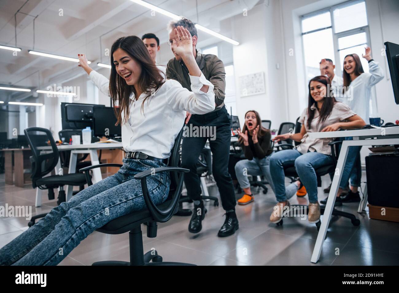 Positive young people have fun at break time in the office Stock Photo ...