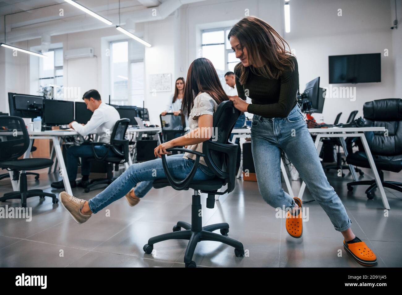 Positive young people have fun at break time in the office Stock Photo ...