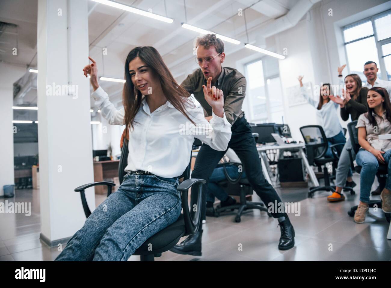 Positive young people have fun at break time in the office Stock Photo ...