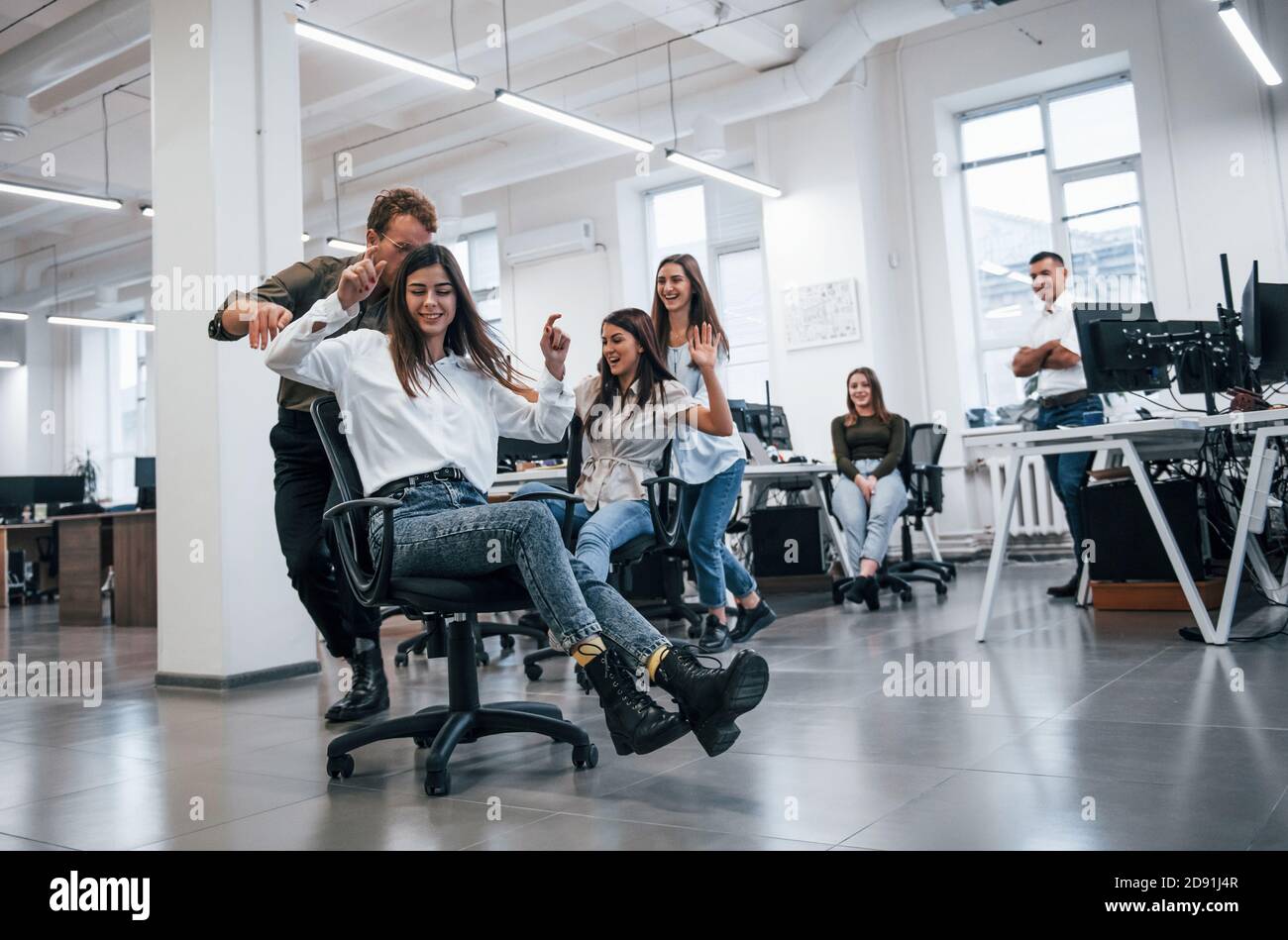 Positive young people have fun at break time in the office Stock Photo ...