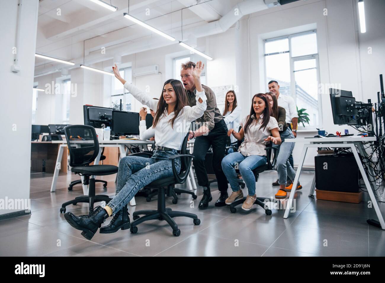 Positive young people have fun at break time in the office Stock Photo ...