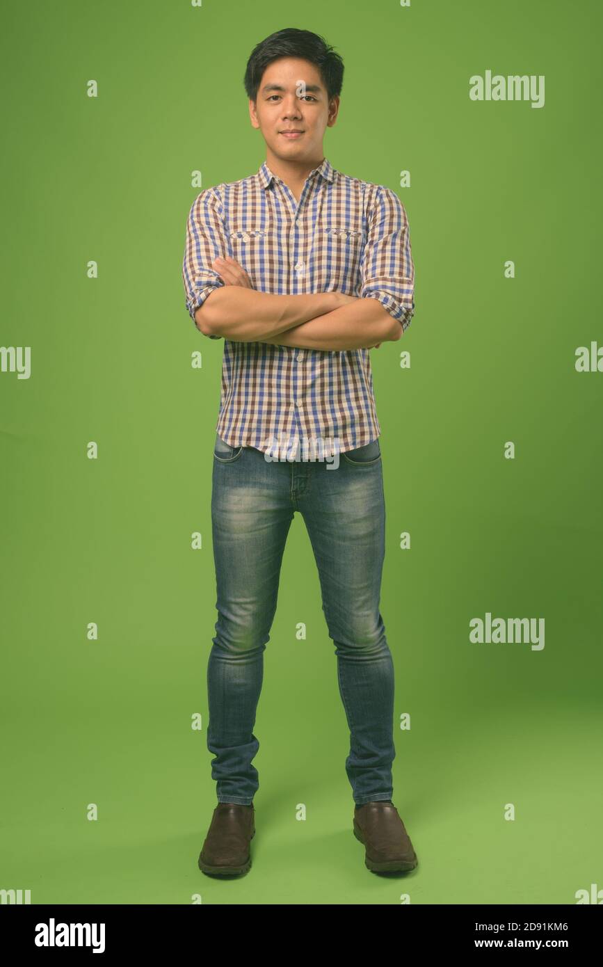 Young handsome Filipino man against green background Stock Photo - Alamy