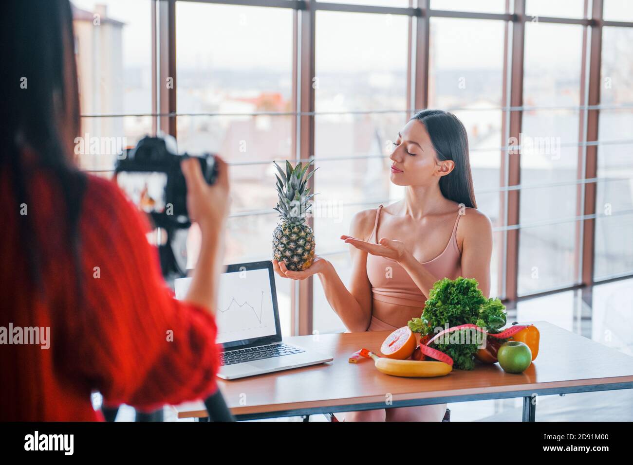 Fitness model have photoshoot by female photographer indoors by the ...