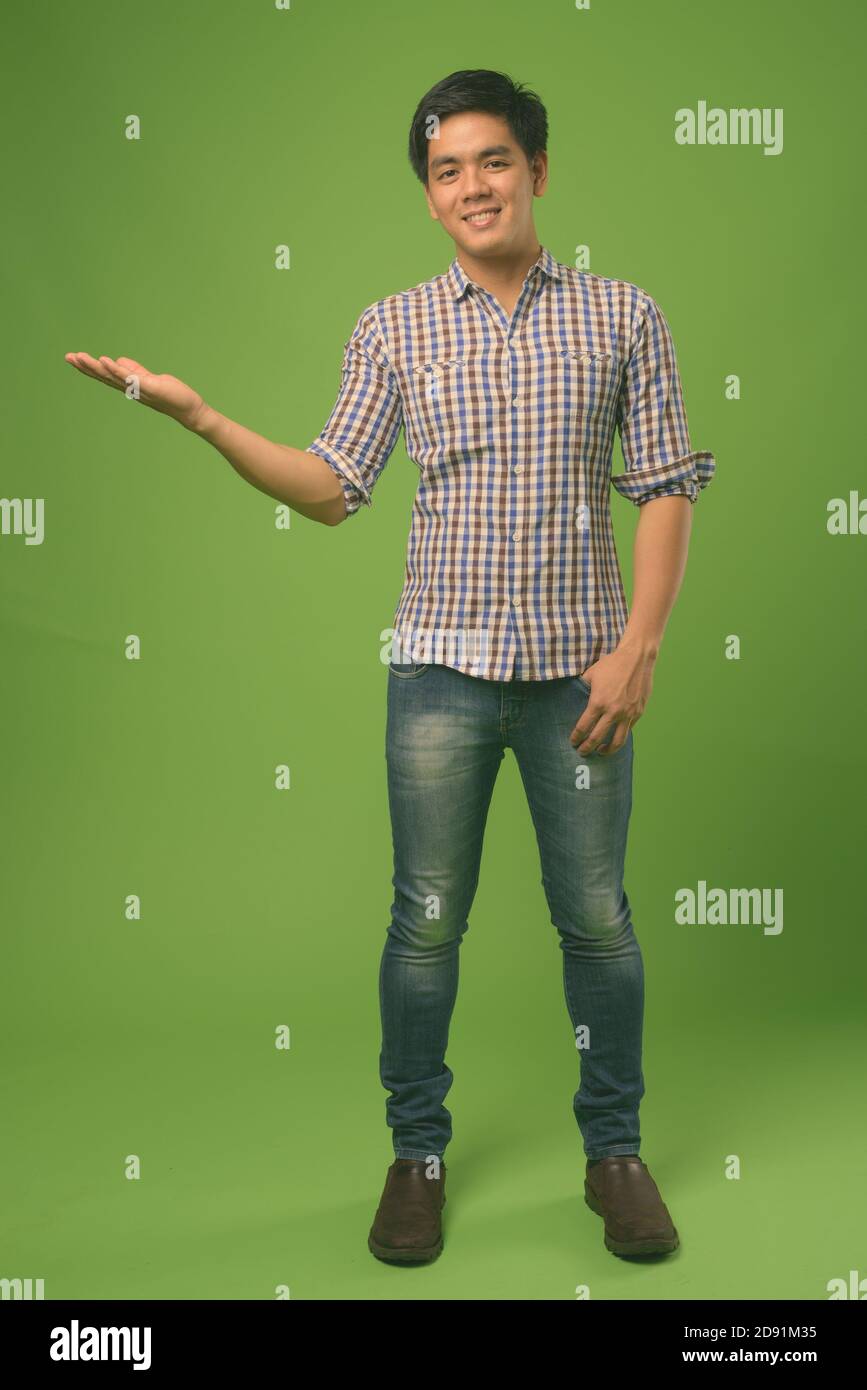 Young handsome Filipino man against green background Stock Photo - Alamy