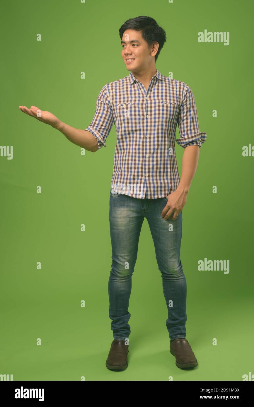 Young handsome Filipino man against green background Stock Photo - Alamy