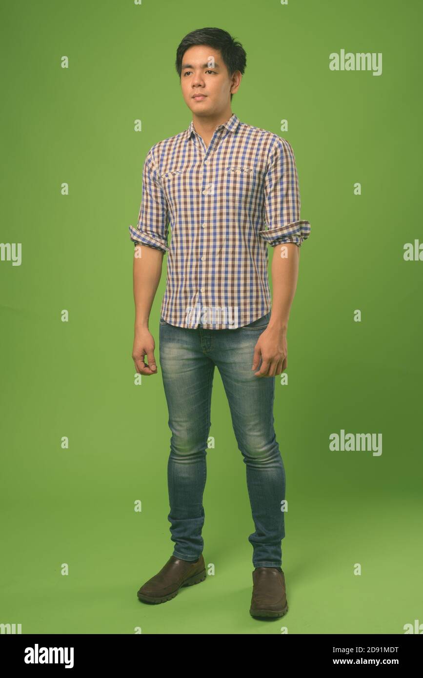 Young handsome Filipino man against green background Stock Photo - Alamy