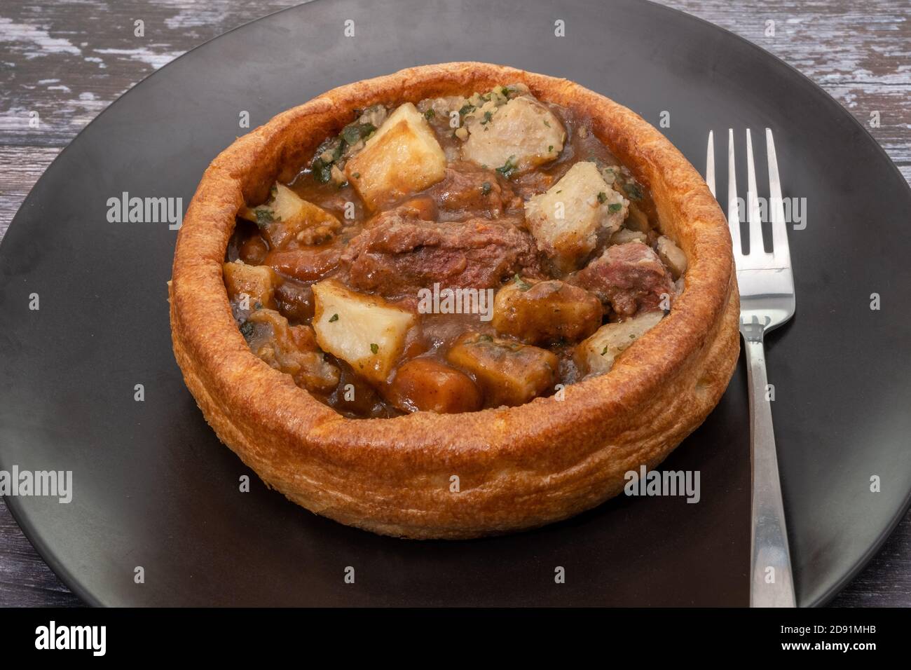 Filled Yorkshire pudding dinner with beef and vegetables Stock Photo ...
