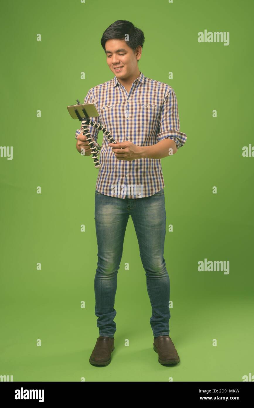 Young handsome Filipino man against green background Stock Photo - Alamy