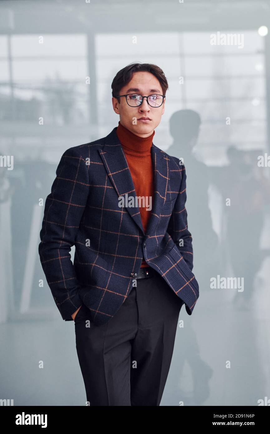 Young business man in luxury suit and formal clothes posing for the ...
