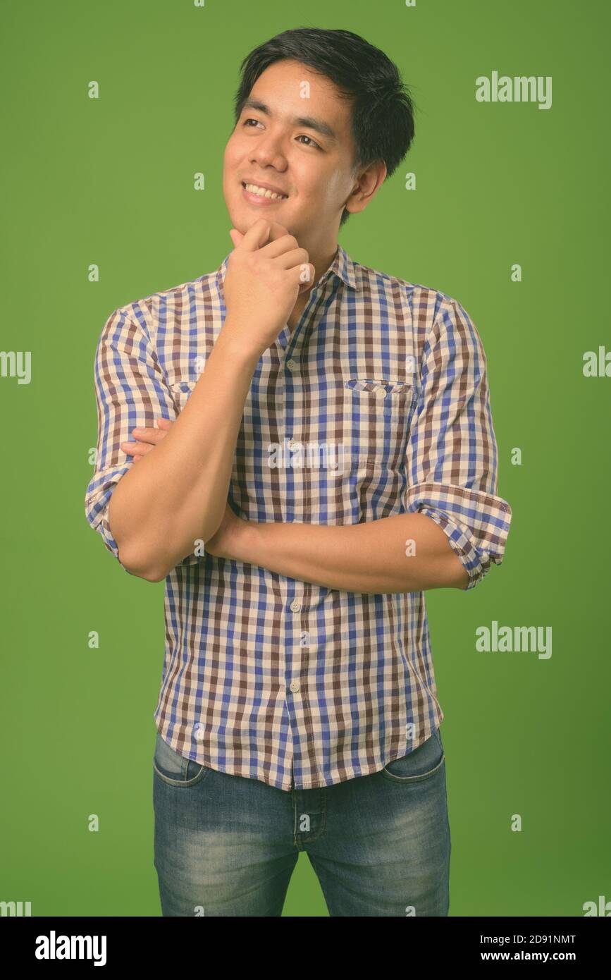 Young handsome Filipino man against green background Stock Photo - Alamy