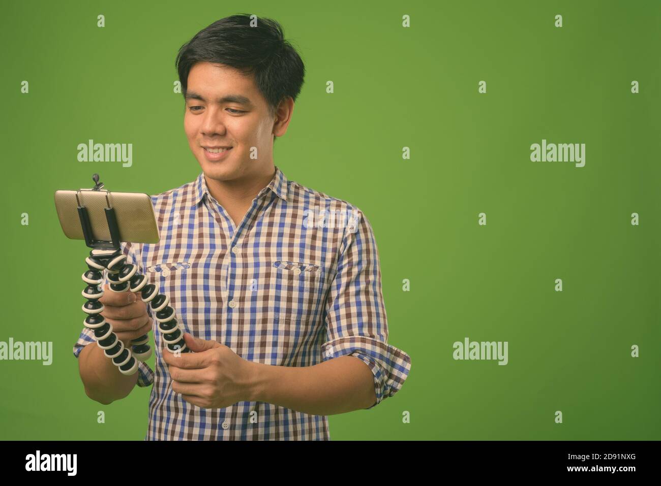 Young handsome Filipino man against green background Stock Photo - Alamy
