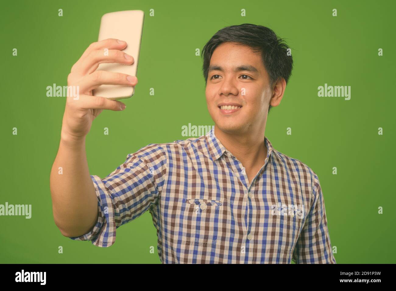 Young handsome Filipino man against green background Stock Photo - Alamy