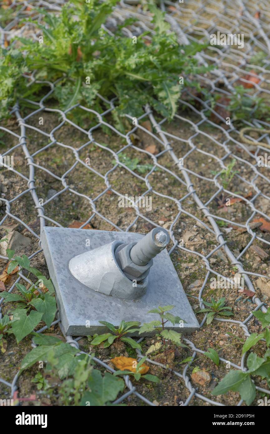 Chain link rockfall protection mesh and anchor in the town of ...