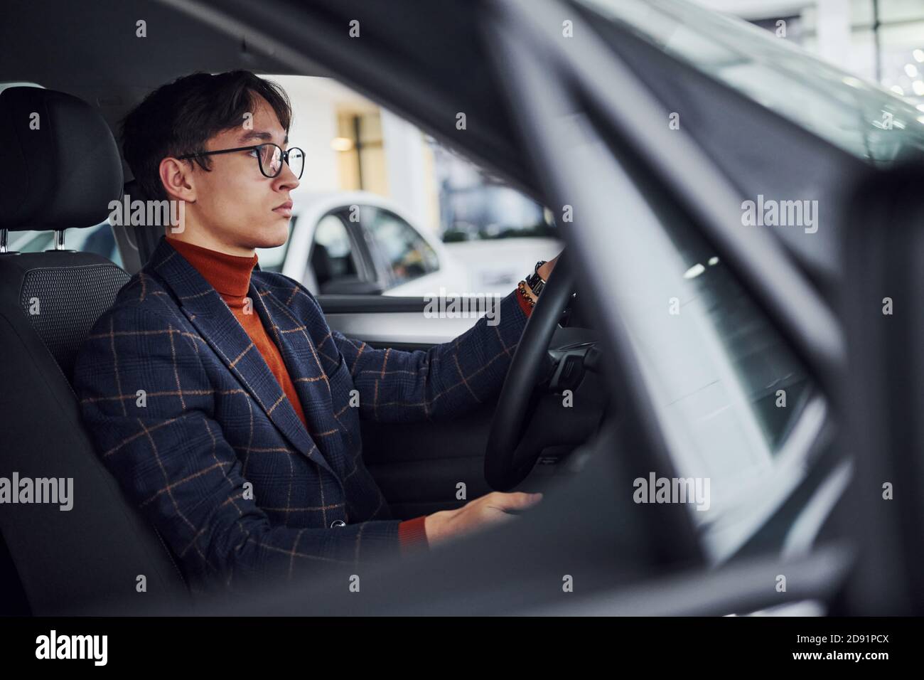 Man in eyewear and formal clothes sitting inside of modern car Stock ...