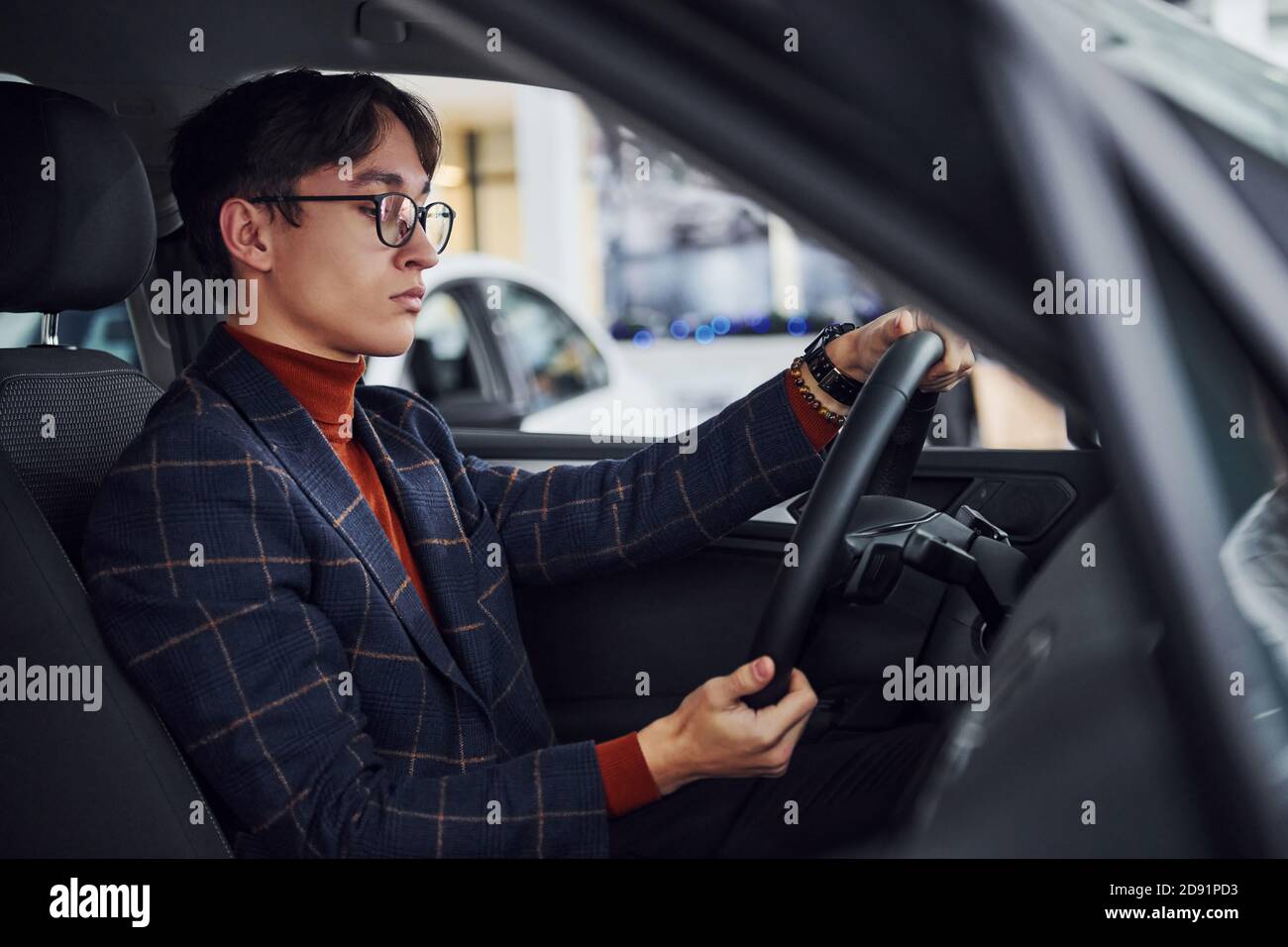 Man in eyewear and formal clothes sitting inside of modern car Stock ...