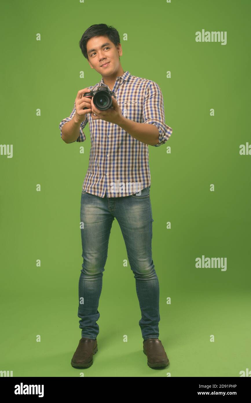 Young handsome Filipino man against green background Stock Photo - Alamy