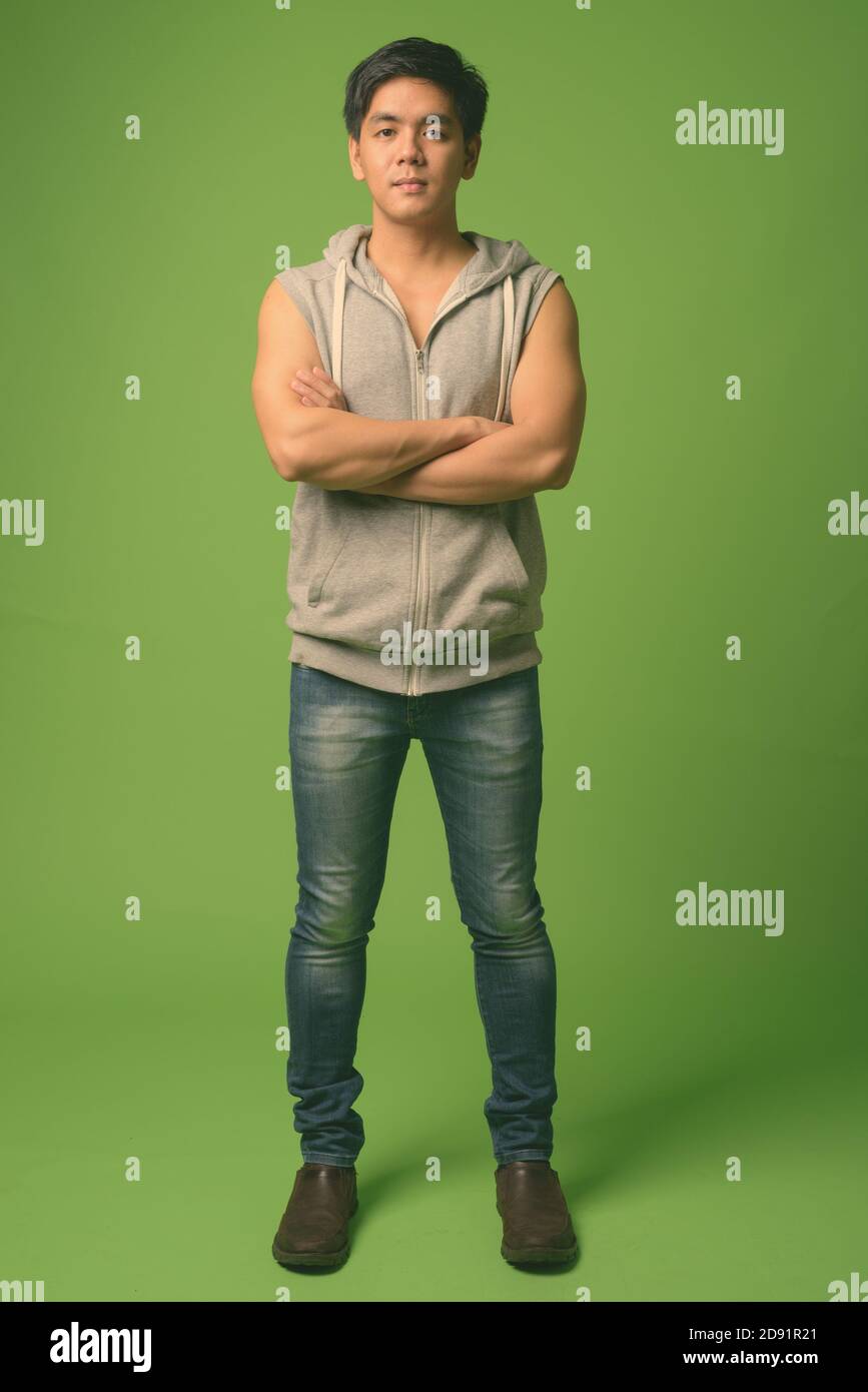 Young handsome Filipino man against green background Stock Photo - Alamy
