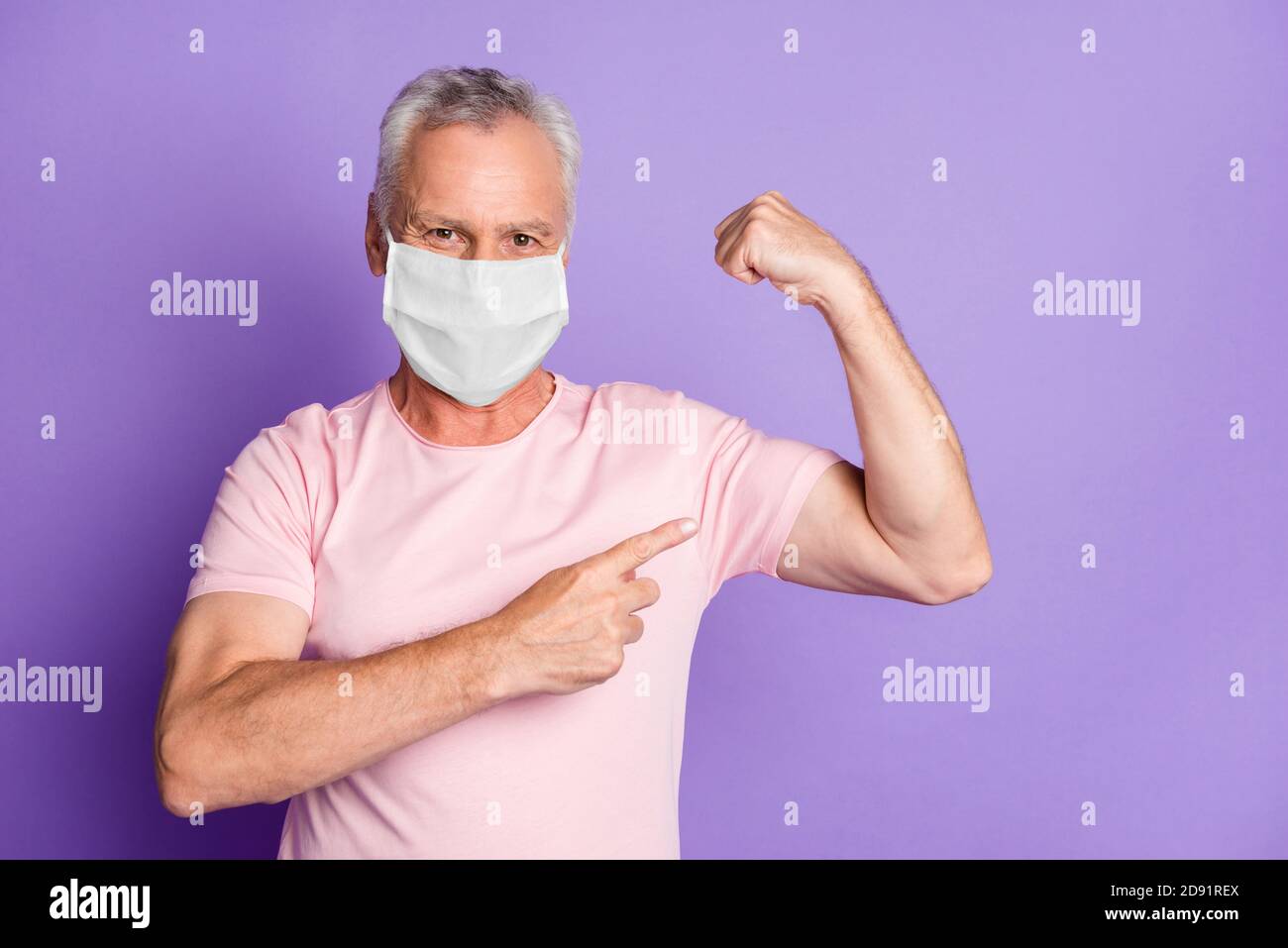 Photo of old man flex muscles point finger wear white face mask ...