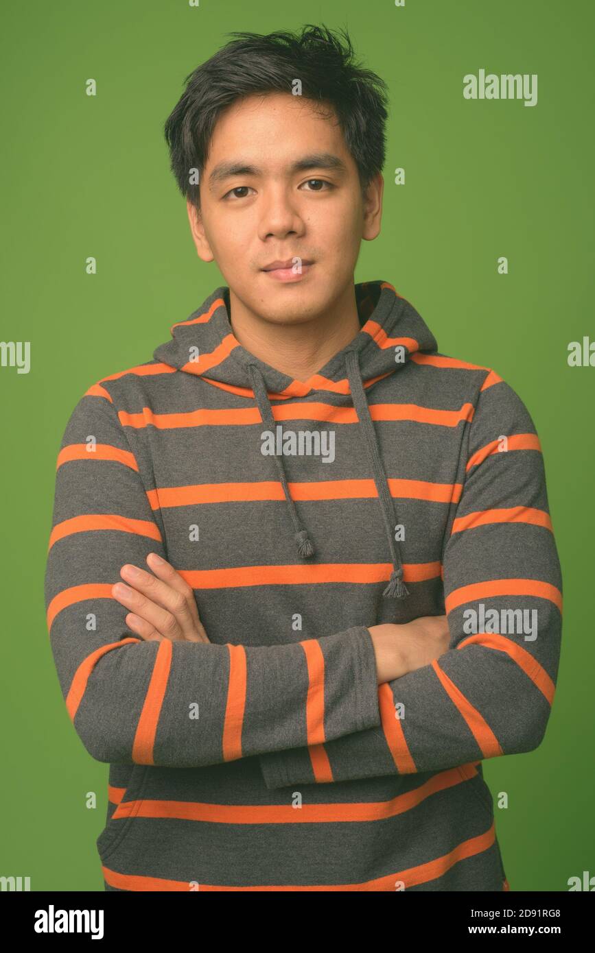 Young handsome Filipino man against green background Stock Photo - Alamy