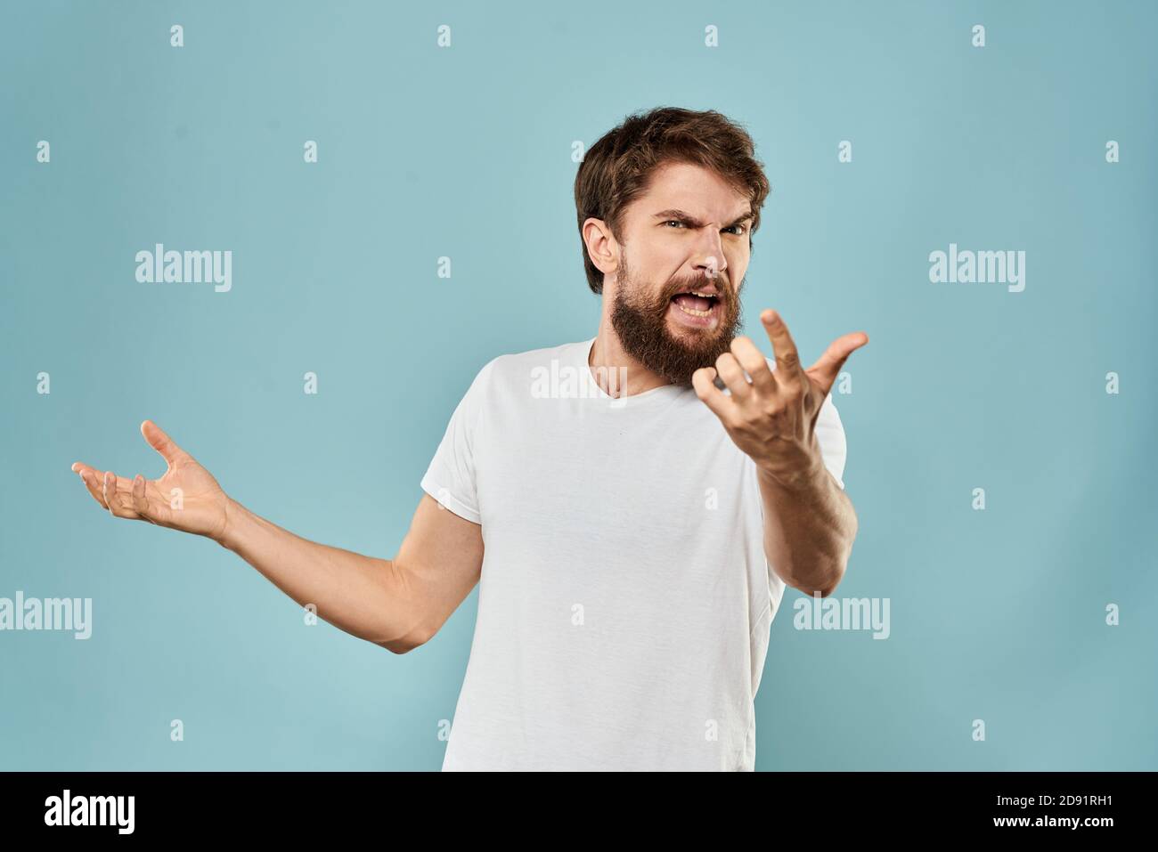 Man gestures with his hands emotions displeasure white t-shirt blue ...