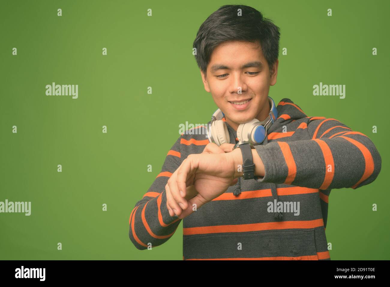 Young handsome Filipino man against green background Stock Photo - Alamy