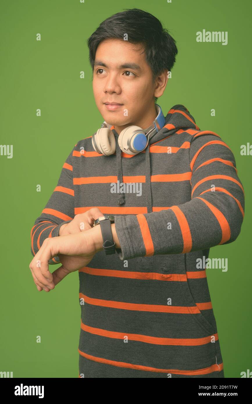 Young handsome Filipino man against green background Stock Photo - Alamy