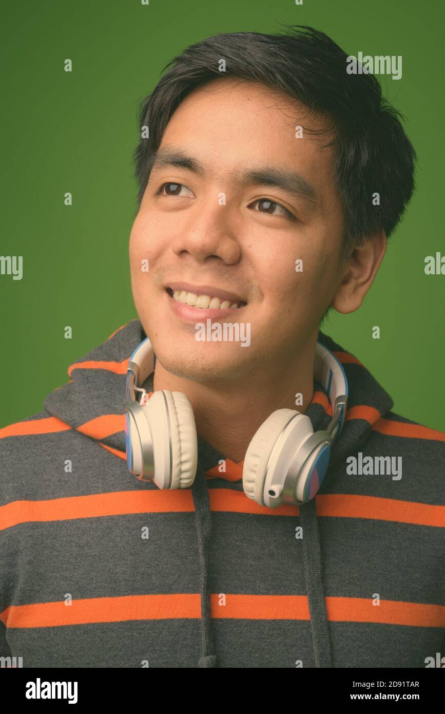 Young handsome Filipino man against green background Stock Photo - Alamy