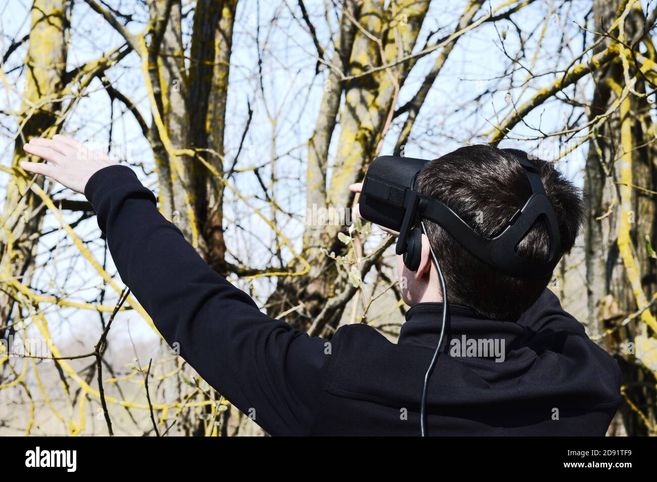 young man try VR glasses outdoors and experiencing virtual technologies ...