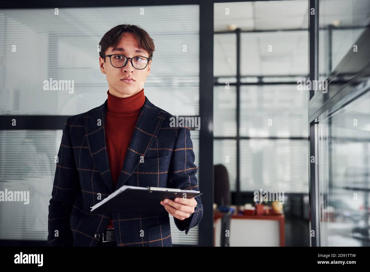 Office worker in glasses and in formal clothes standing indoors Stock ...
