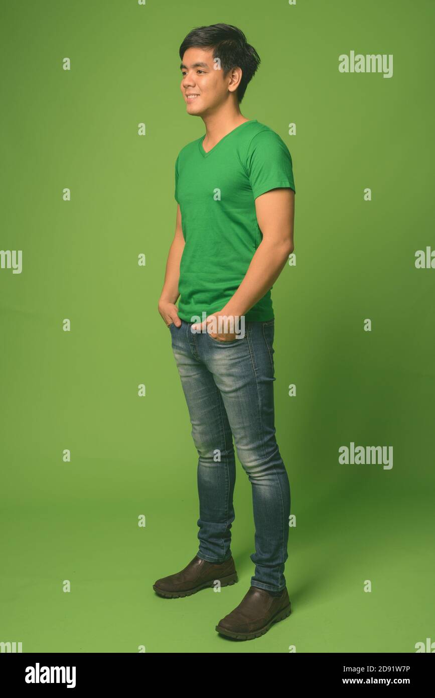 Young handsome Filipino man against green background Stock Photo - Alamy