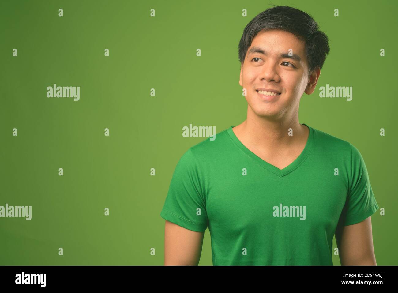 Young handsome Filipino man against green background Stock Photo - Alamy
