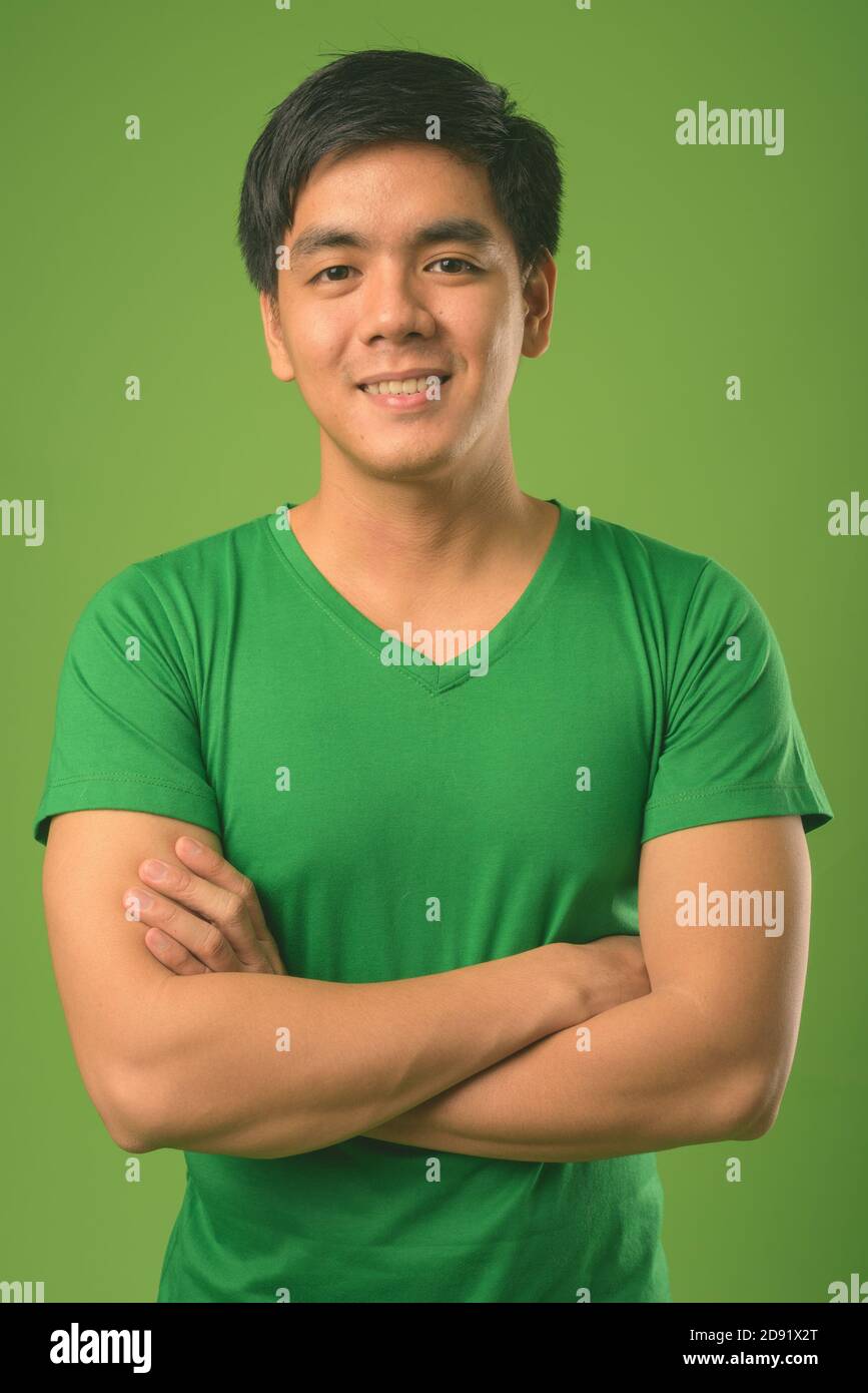 Young handsome Filipino man against green background Stock Photo - Alamy
