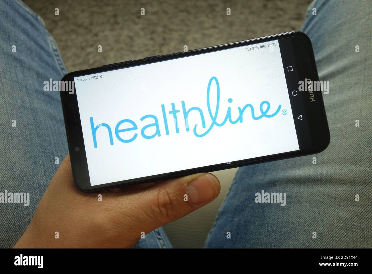 Man holding smartphone with Healthline logo Stock Photo - Alamy