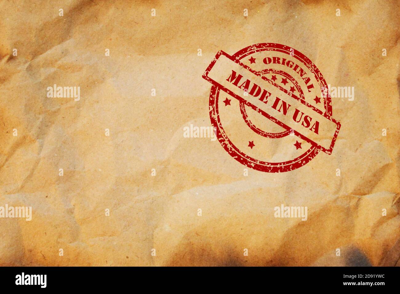 Made in USA stamp printed on crumpled sheet of burnt paper. American ...