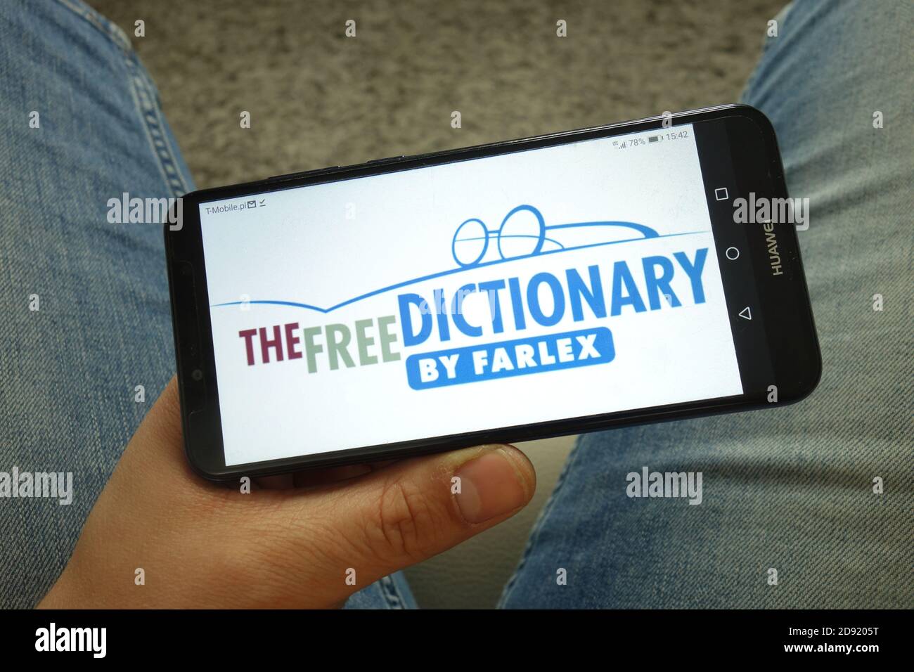 Man holding smartphone with The Free Dictionary by Farlex logo Stock ...