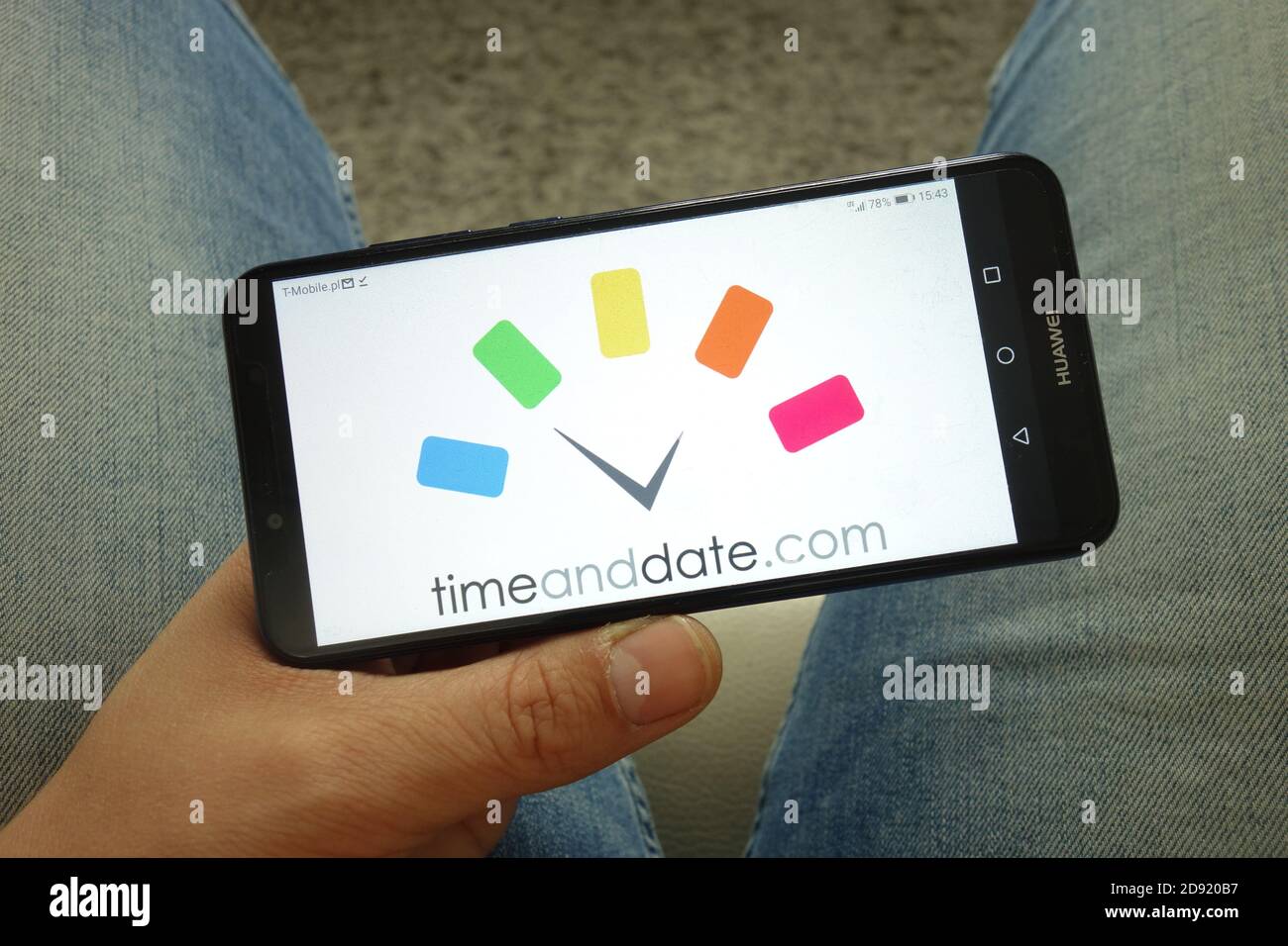 Man holding smartphone with Timeanddate.com website logo Stock Photo ...